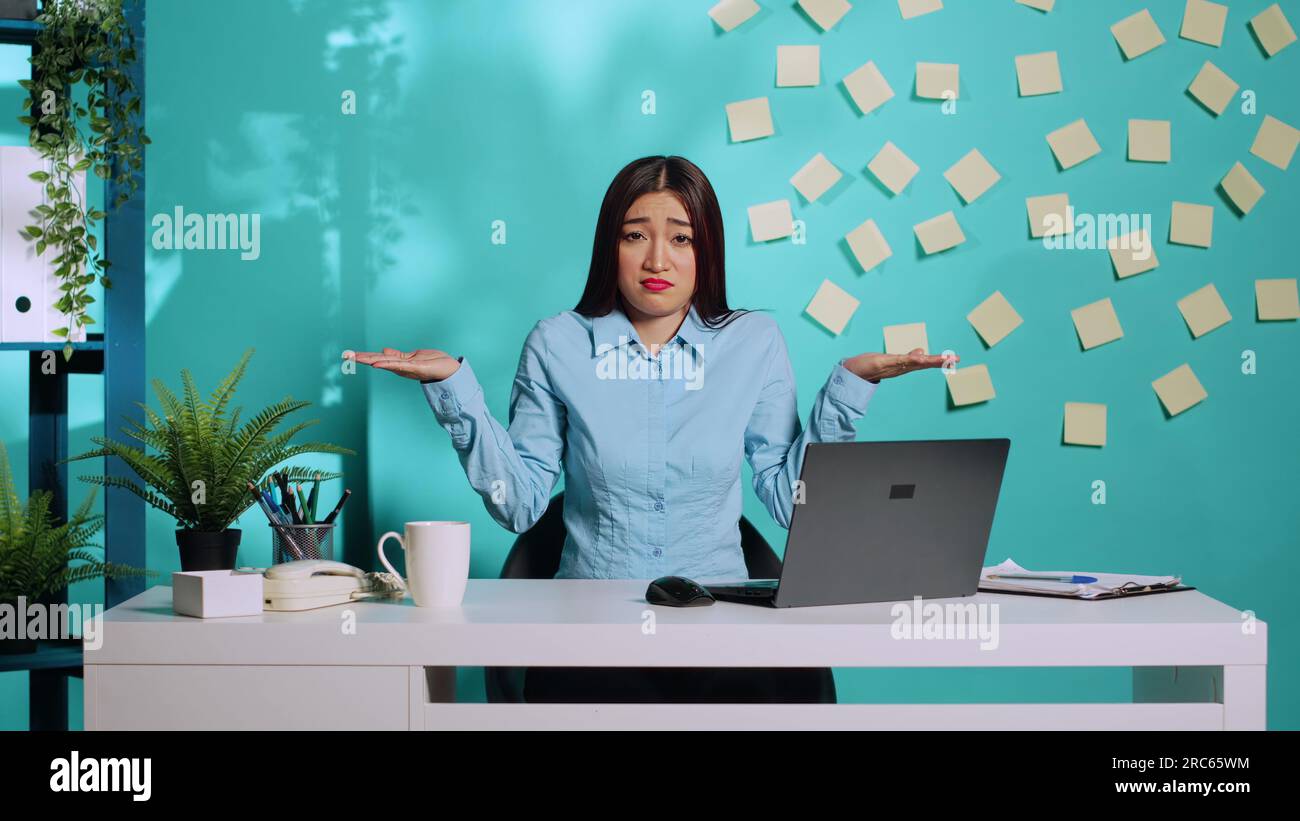 Confused puzzled businesswoman shrugging shoulders showing questioning ...