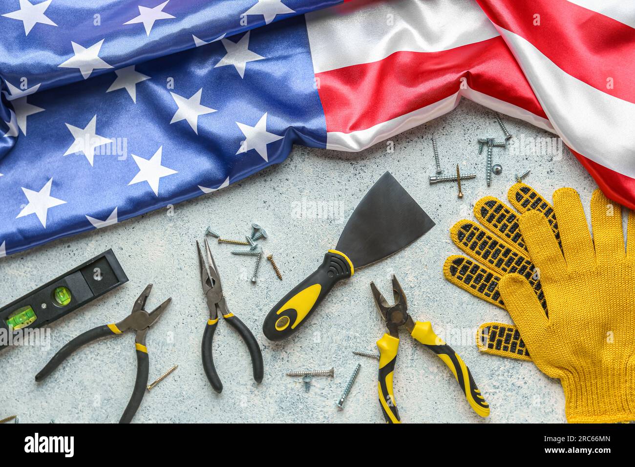 USA flag, different tools, screws and gloves on grey background. Labor ...