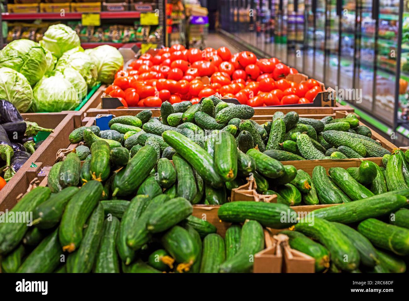 counter with fresh cucumbers, tomatoes, cabbage. Grocery store. Farming ...
