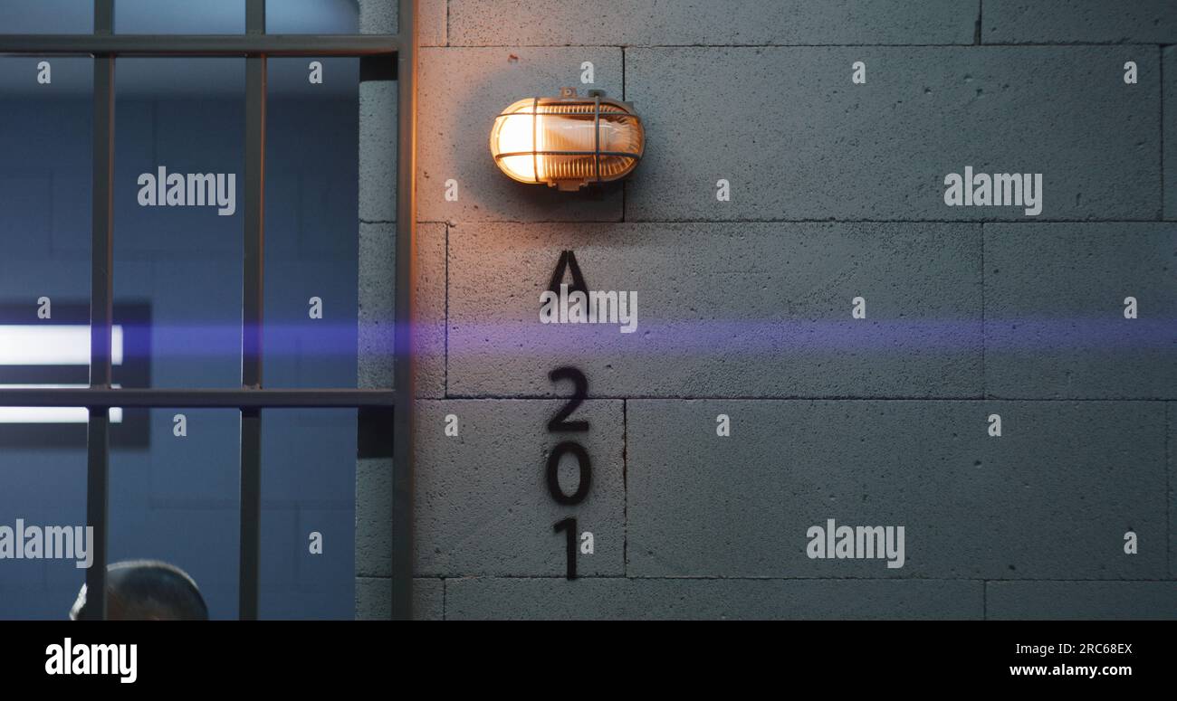 Number of jail cell on the wall. Elderly criminal in orange uniform ...