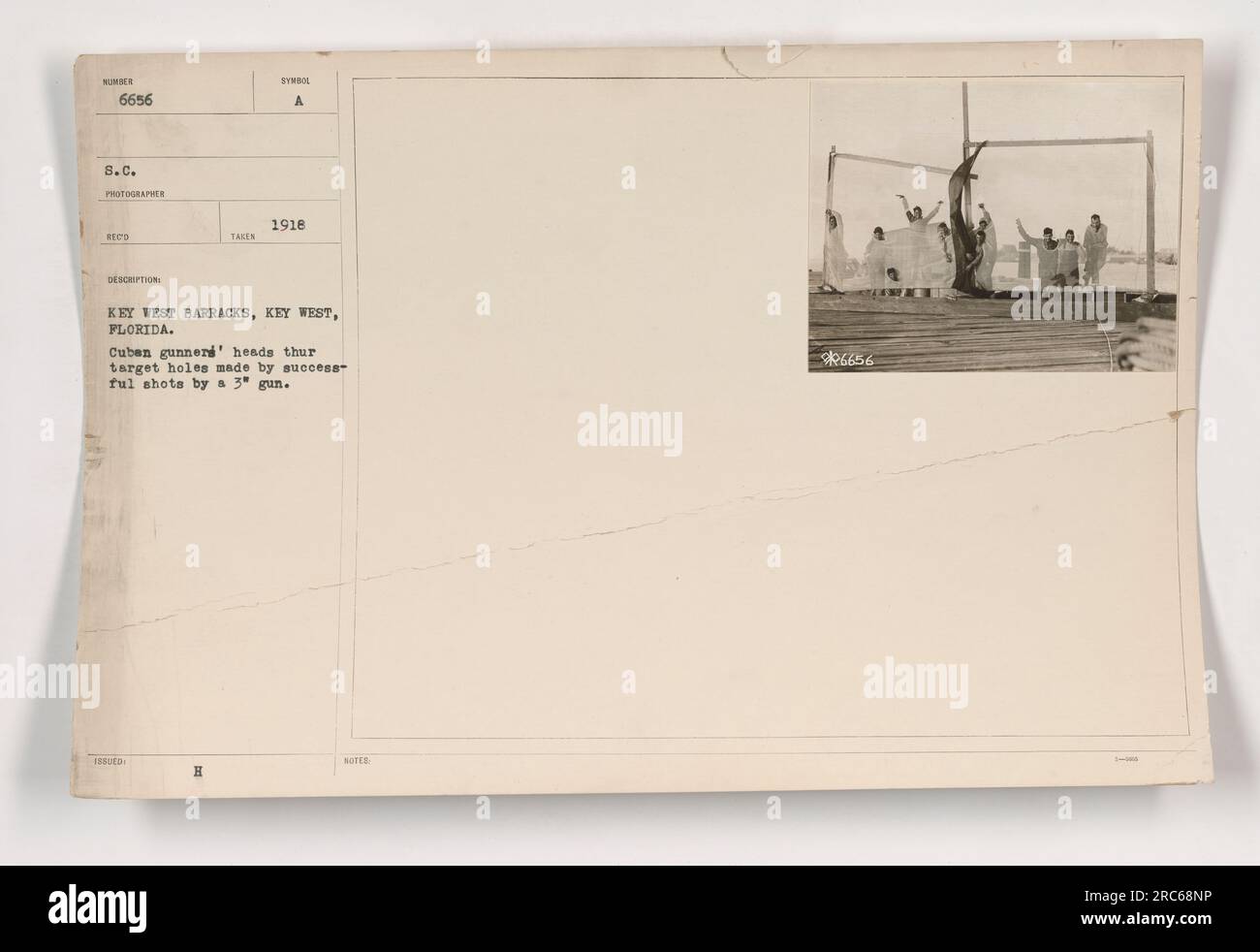 A Cuban gunner observes through target holes created by successful ...