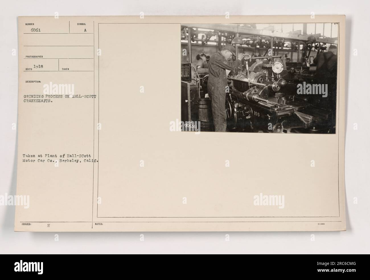 A worker at the Hall-Scott Motor Car Co. in Berkeley, California, is ...