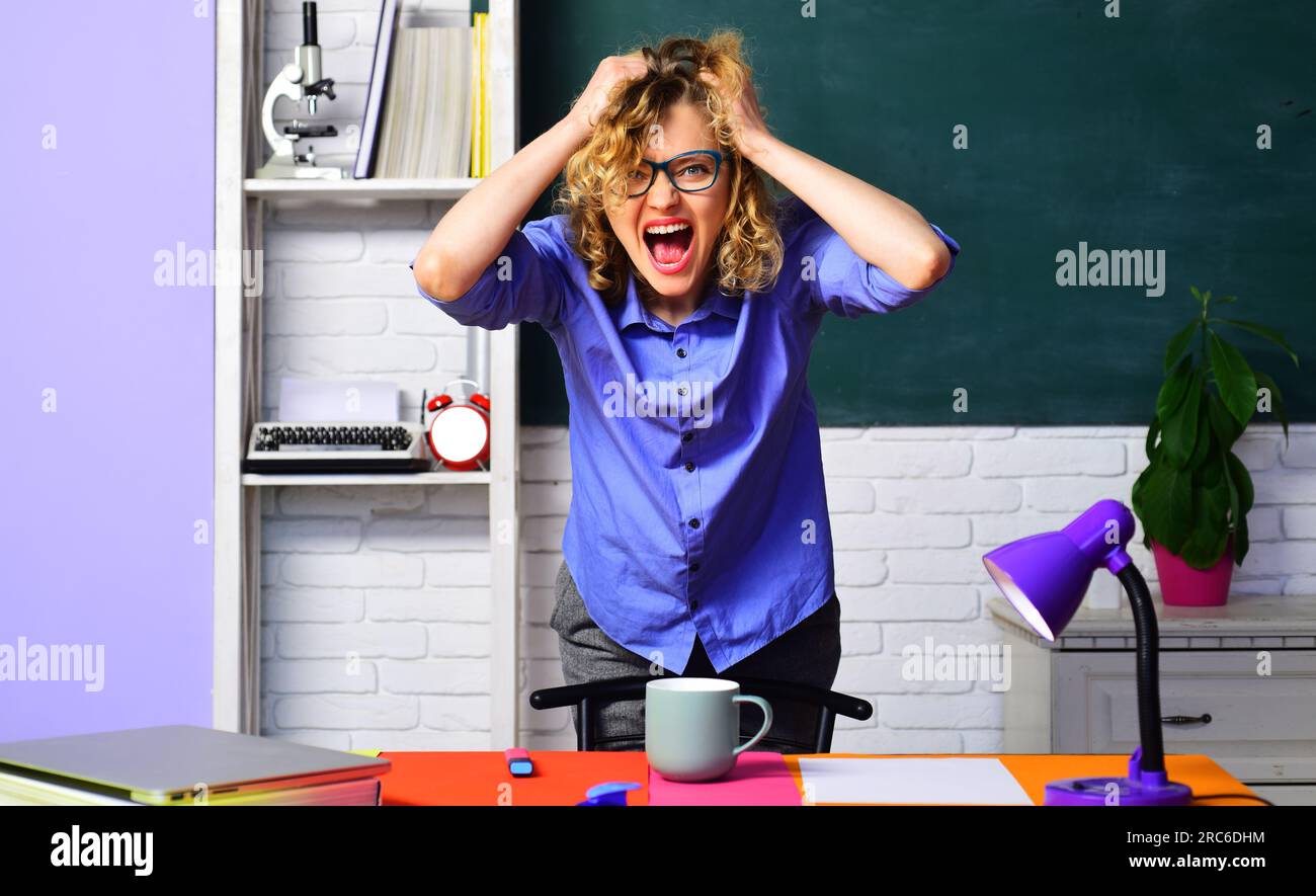 Angry screaming female teacher in classroom. Hard school work. Portrait ...