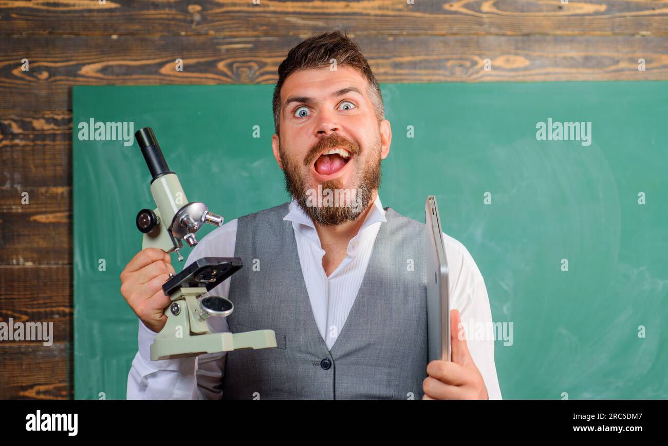Funny college teacher with computer and microscope. Excited tutor with ...
