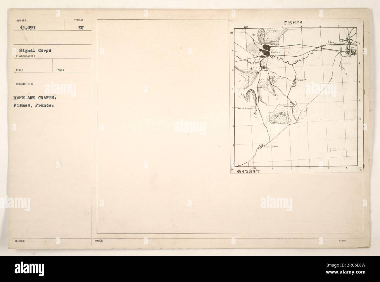 A soldier from the Signal Corps is seen organizing and studying maps ...
