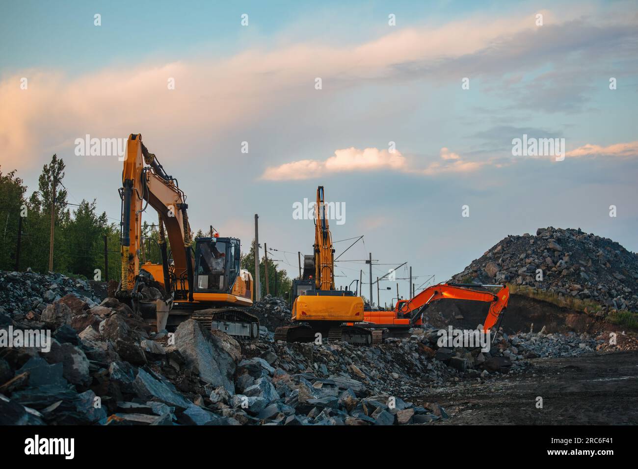 Excavators working on earthmoving at open pit mine in mining and ...