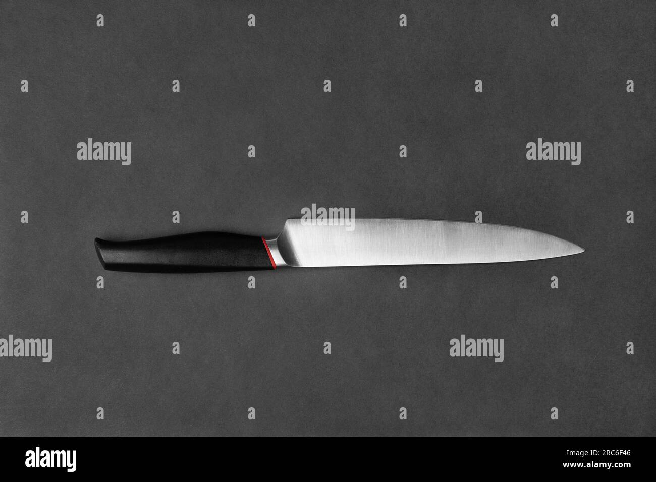 Kitchen knife with a black handle on a black background. Large knife on ...