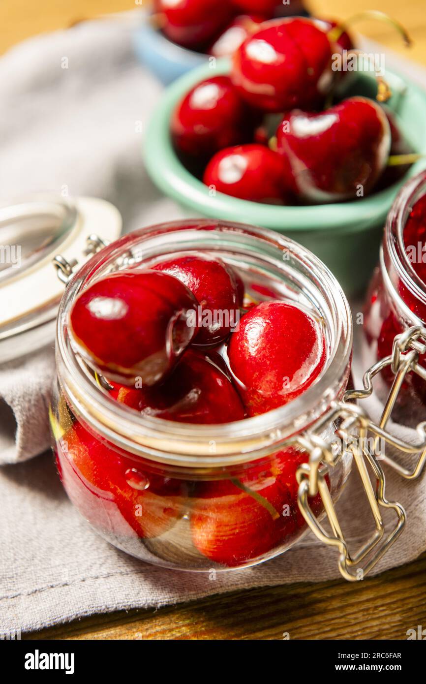 some ripe canned cherries in a clear glass jar with a lid Stock Photo ...