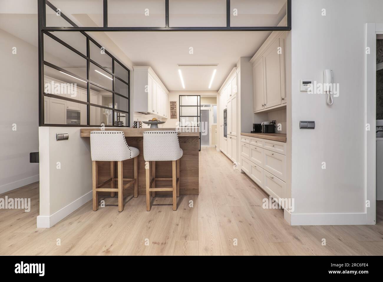 Front image of a spacious kitchen without doors with a metal and glass ...