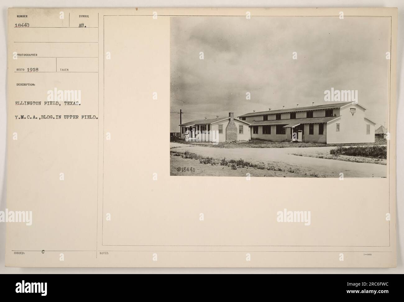 Soldiers standing in Ellington Field, Texas, with a Y.M.C.A. building ...