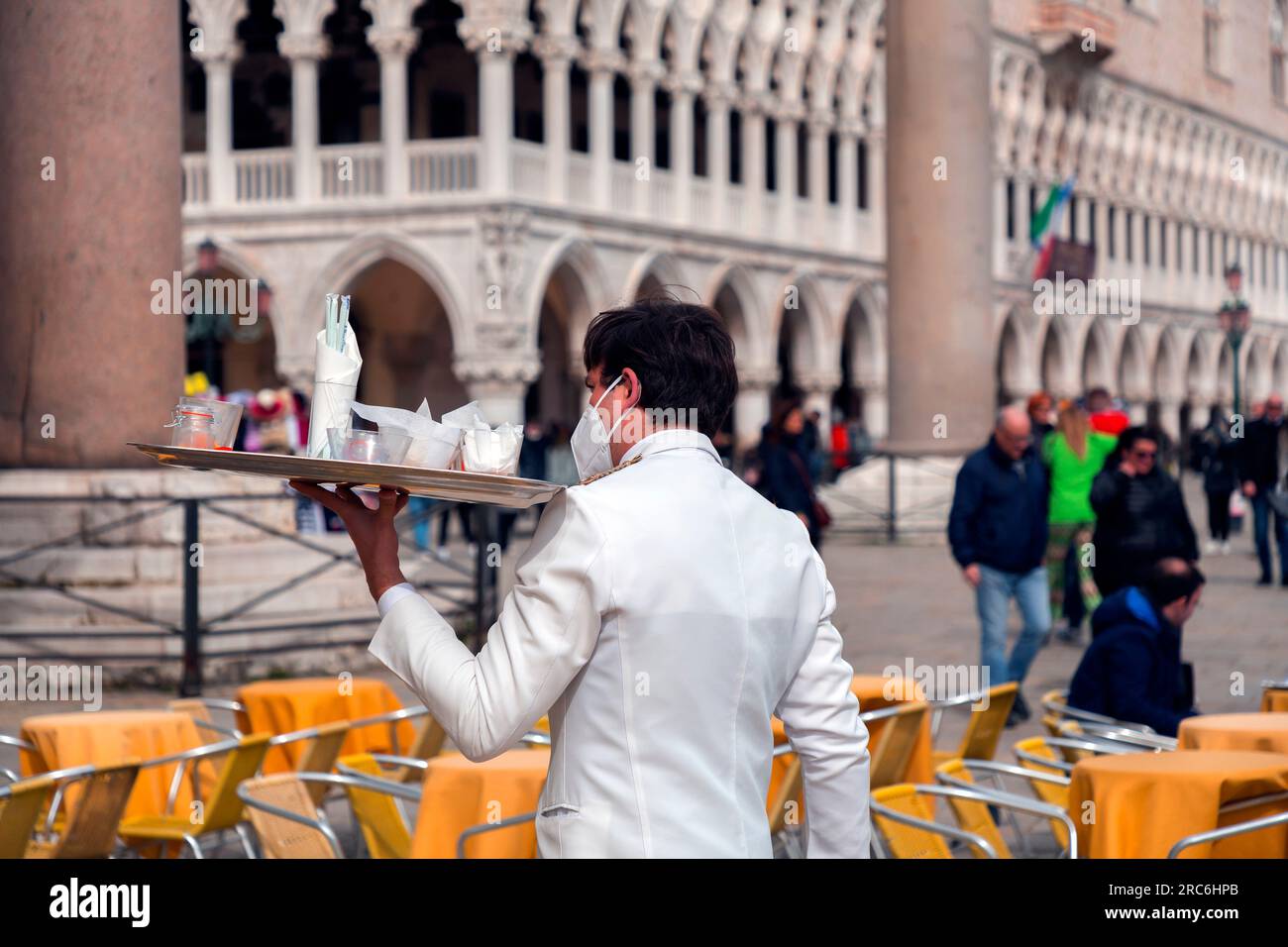 Venice, Italy - April 2, 2022: Young waiter in white suits and wearing ...