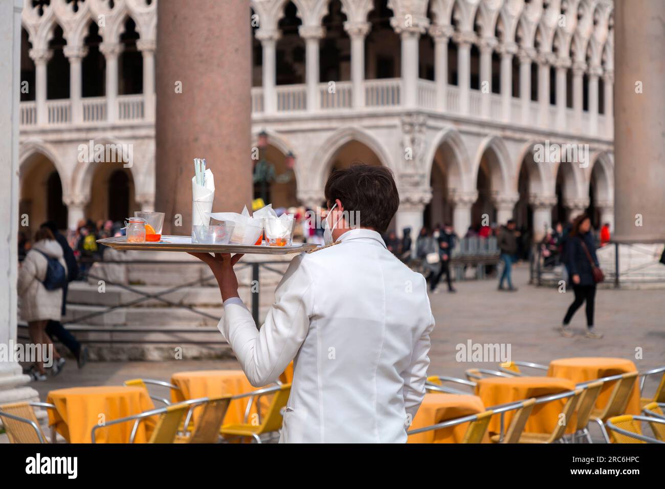 Venice, Italy - April 2, 2022: Young waiter in white suits and wearing ...