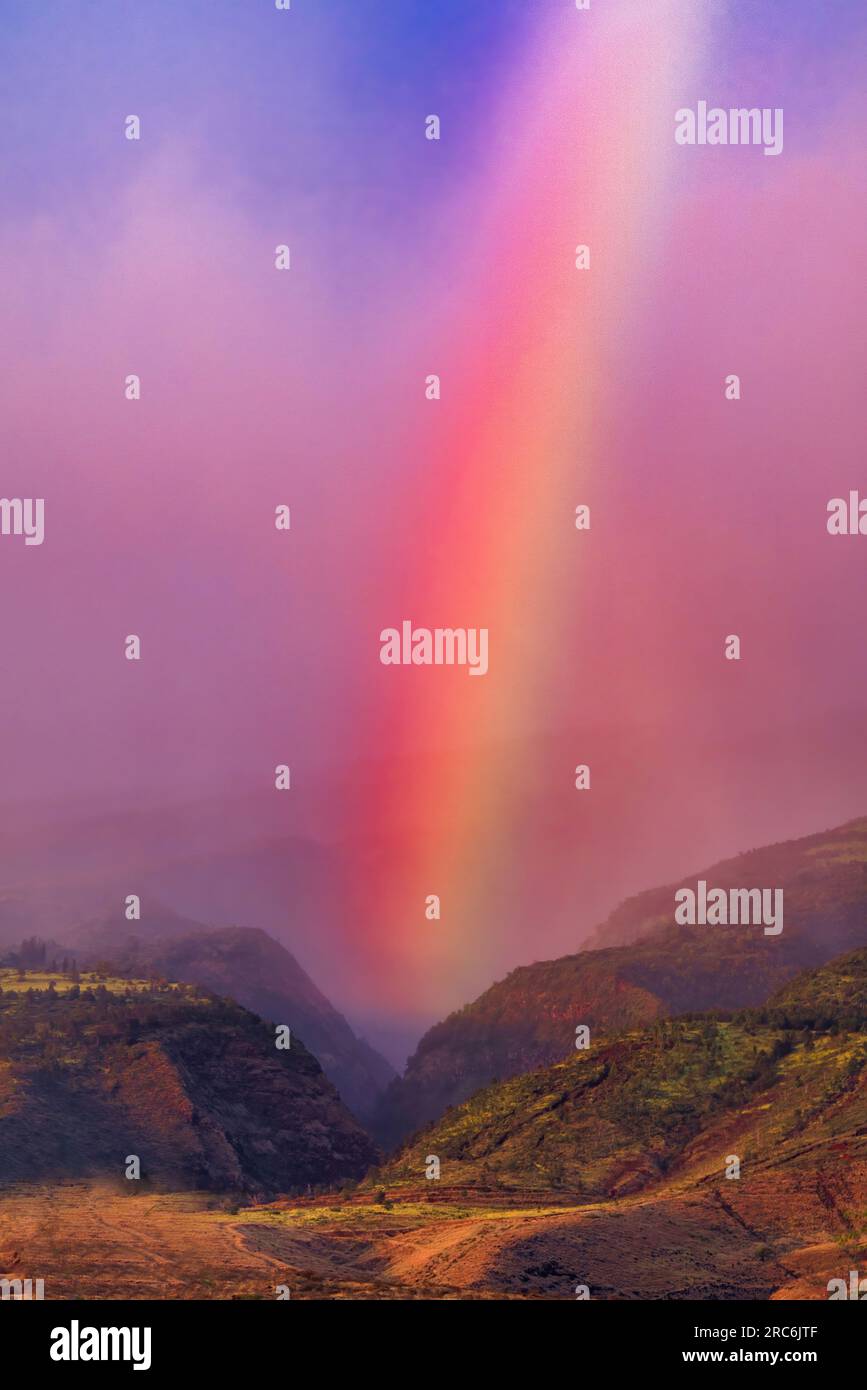Stunning scenic of an evening rainbow nestled in a maui valley Stock ...