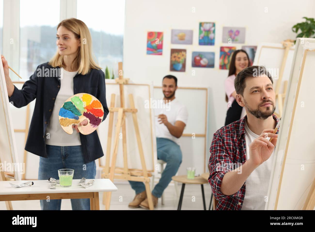 Group of students attending painting class in studio. Creative hobby ...