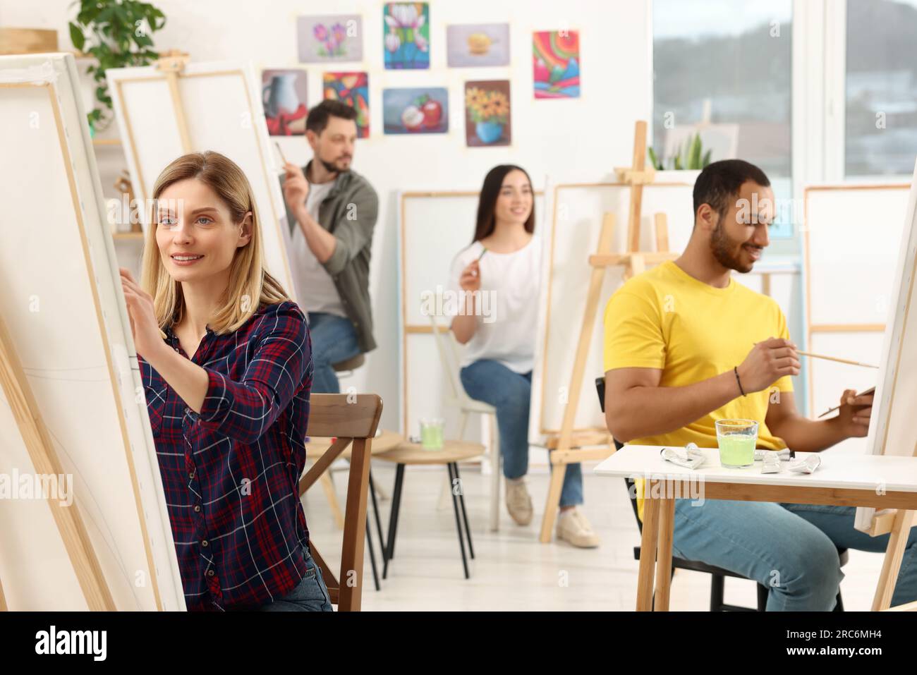Group of students attending painting class in studio. Creative hobby ...