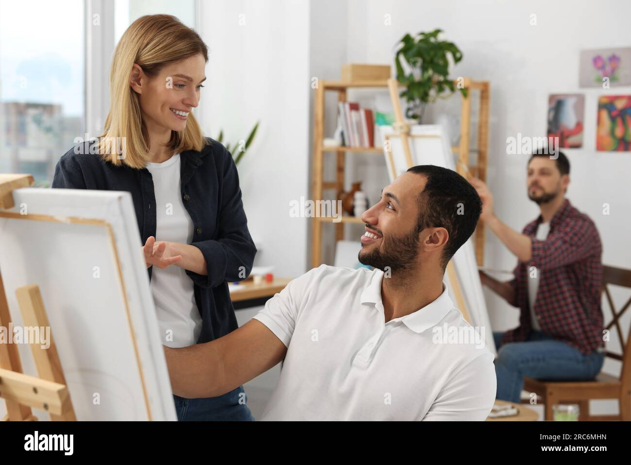 Artist and her students having painting class in studio. Creative hobby ...