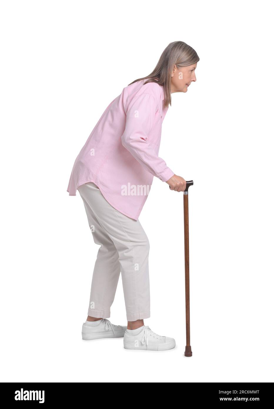Senior woman with walking cane on white background Stock Photo - Alamy
