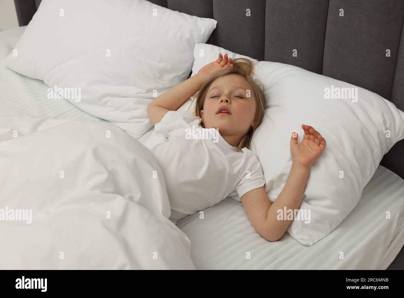 Little girl snoring while sleeping in bed Stock Photo - Alamy