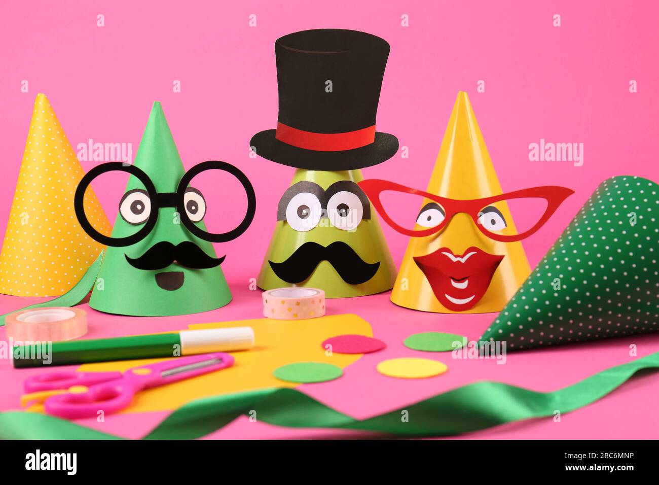 Funny party hats and different materials on pink background. Handmade ...