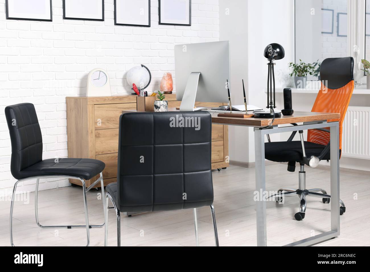Stylish director's workplace with comfortable desk, computer and chairs ...
