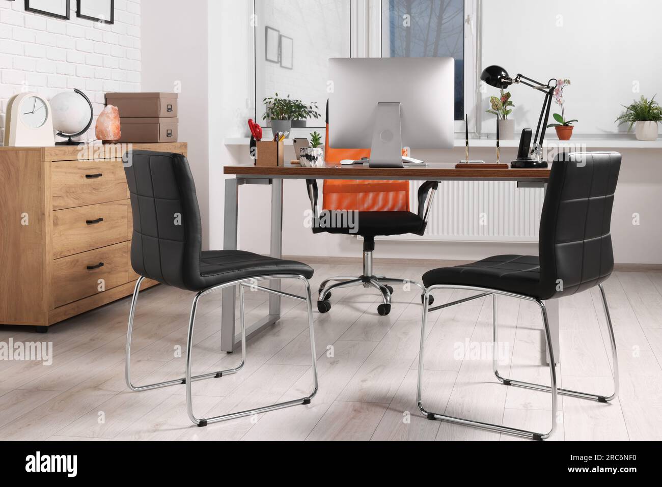 Stylish director's workplace with comfortable desk, computer and chairs ...
