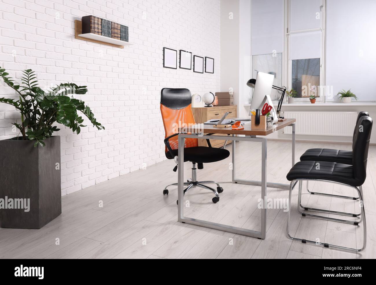 Stylish director's workplace with comfortable desk, computer and chairs ...