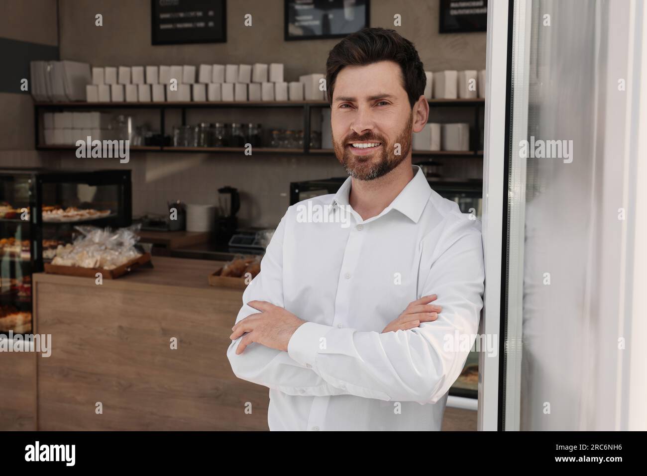 Happy business owner in bakery shop. Space for text Stock Photo - Alamy
