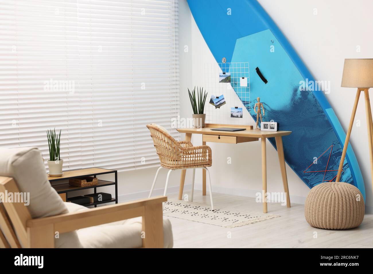 SUP board, workplace and sofa in room. Interior design Stock Photo - Alamy