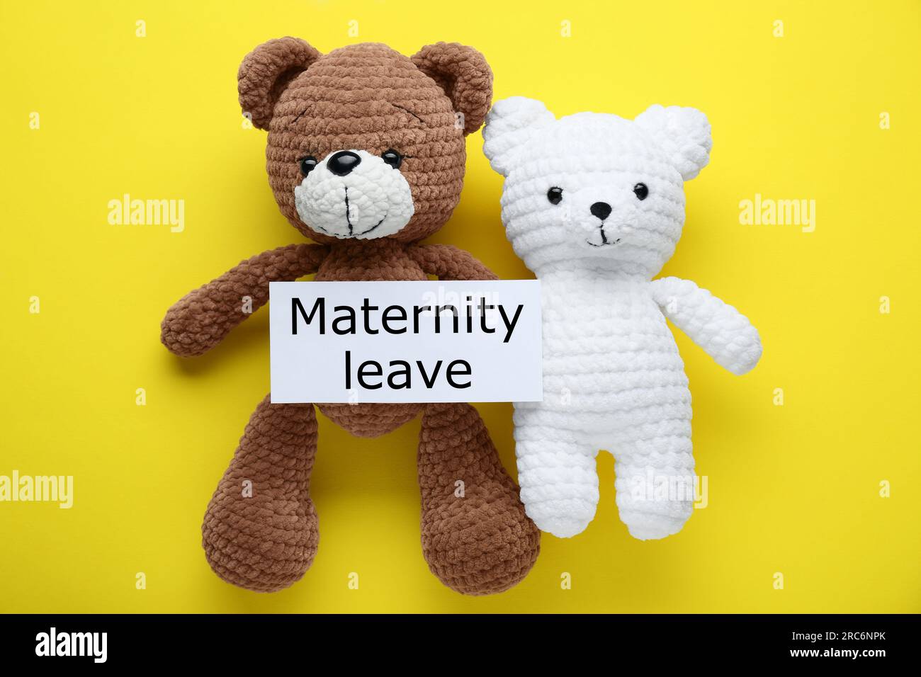Toy bears and note with text Maternity Leave on yellow background, flat ...