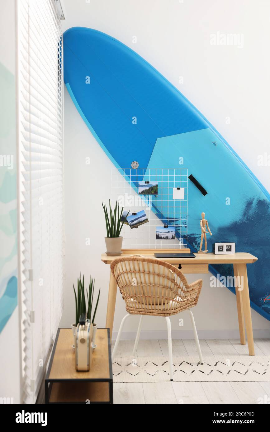 SUP board and workplace in room. Interior design Stock Photo - Alamy