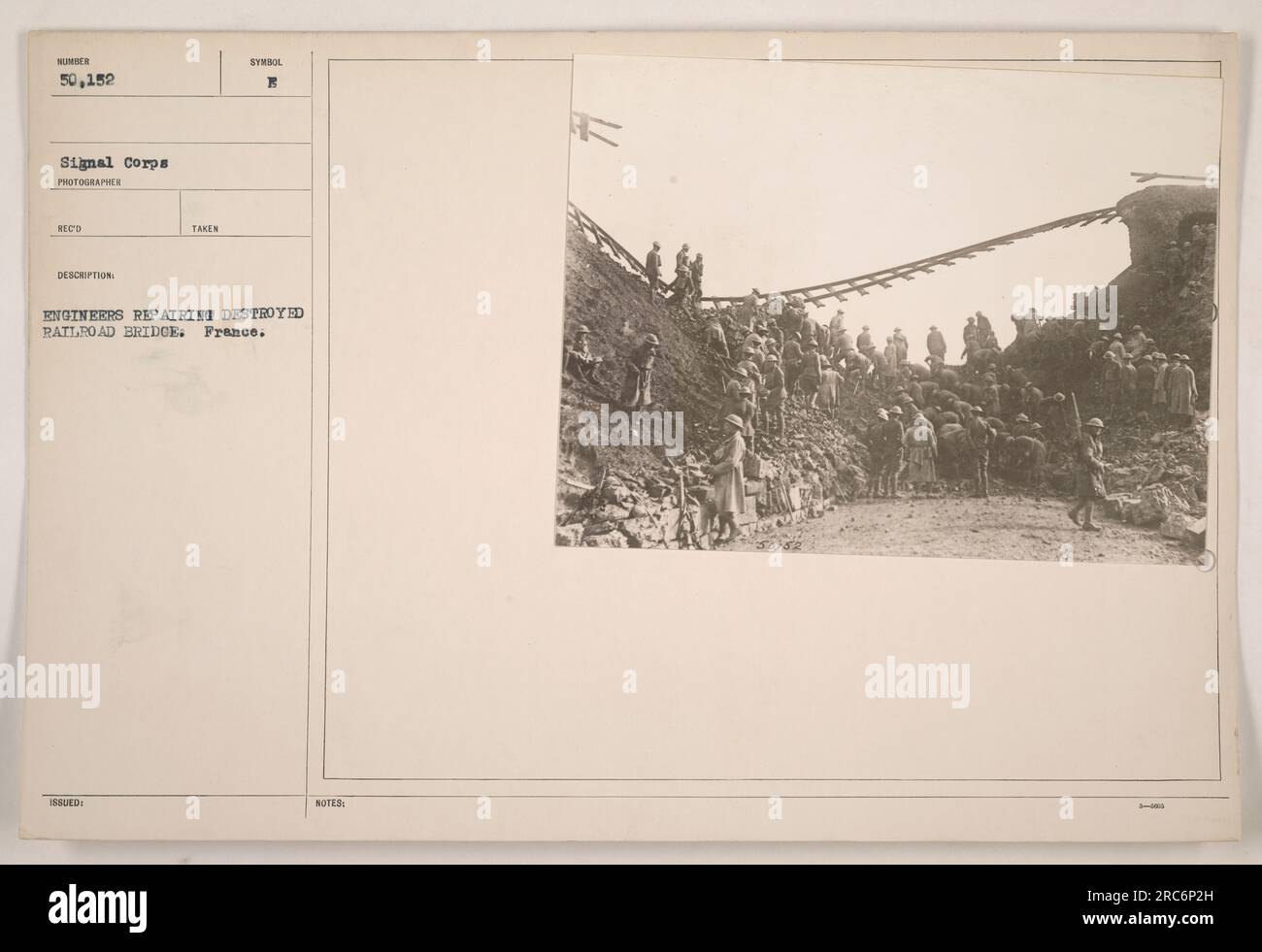 Engineers can be seen in the photograph repairing a railroad bridge ...
