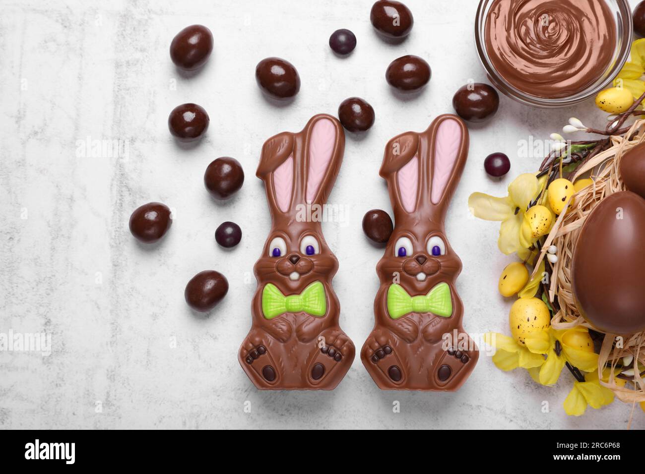 Flat lay composition with chocolate Easter bunnies, eggs and candies on ...