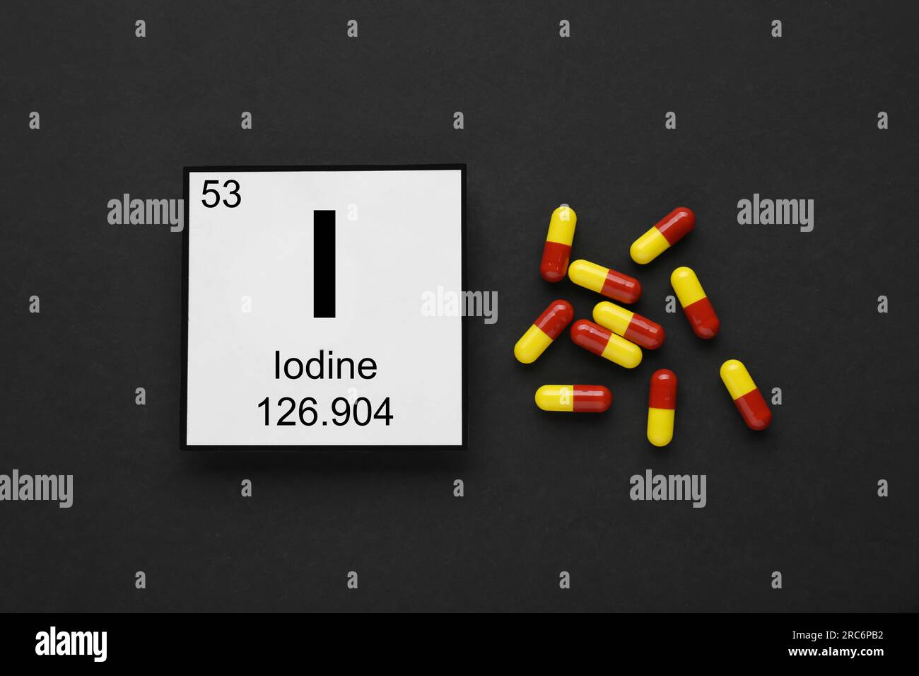 Card with iodine element and pills on black background, flat lay Stock ...