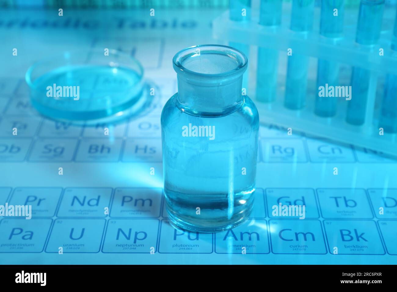 Laboratory glassware and petri dish on periodic table of elements ...