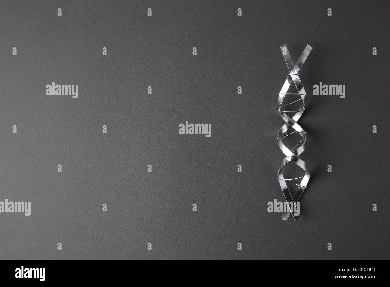DNA molecular chain model made of metal on grey background, top view ...