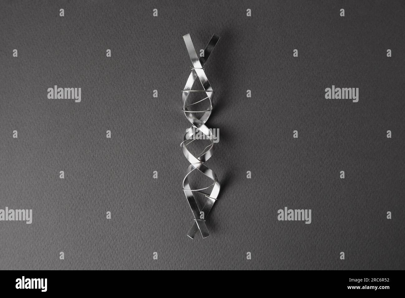 DNA molecular chain model made of metal on grey background, top view ...