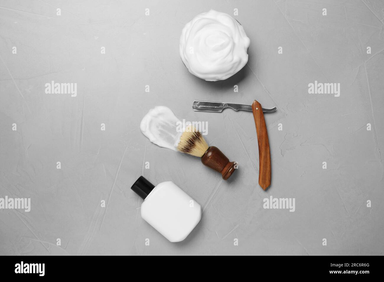 Set of men's shaving tools and foam on light gray textured table, flat ...