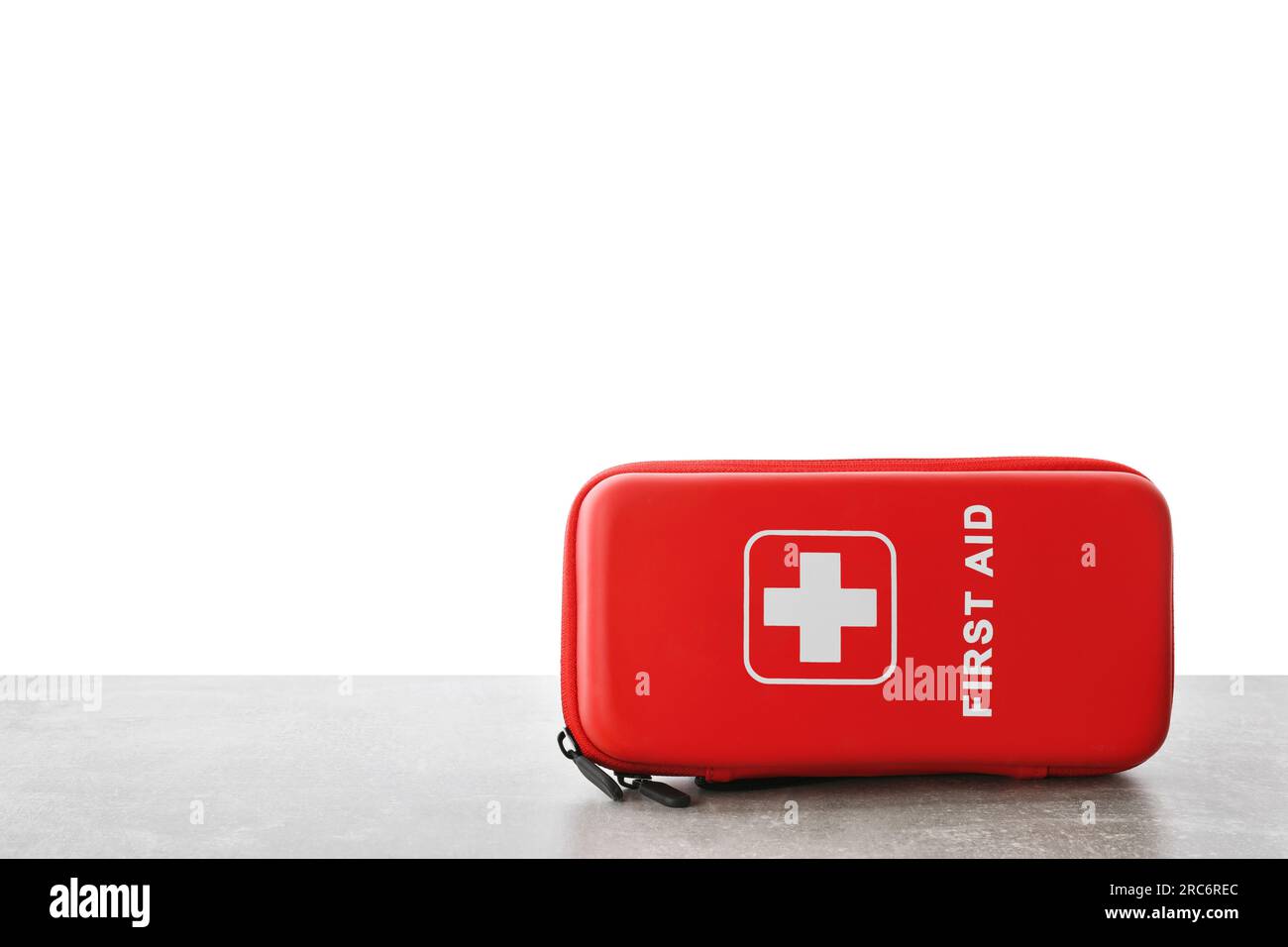 First aid kit on light grey table against white background Stock Photo ...
