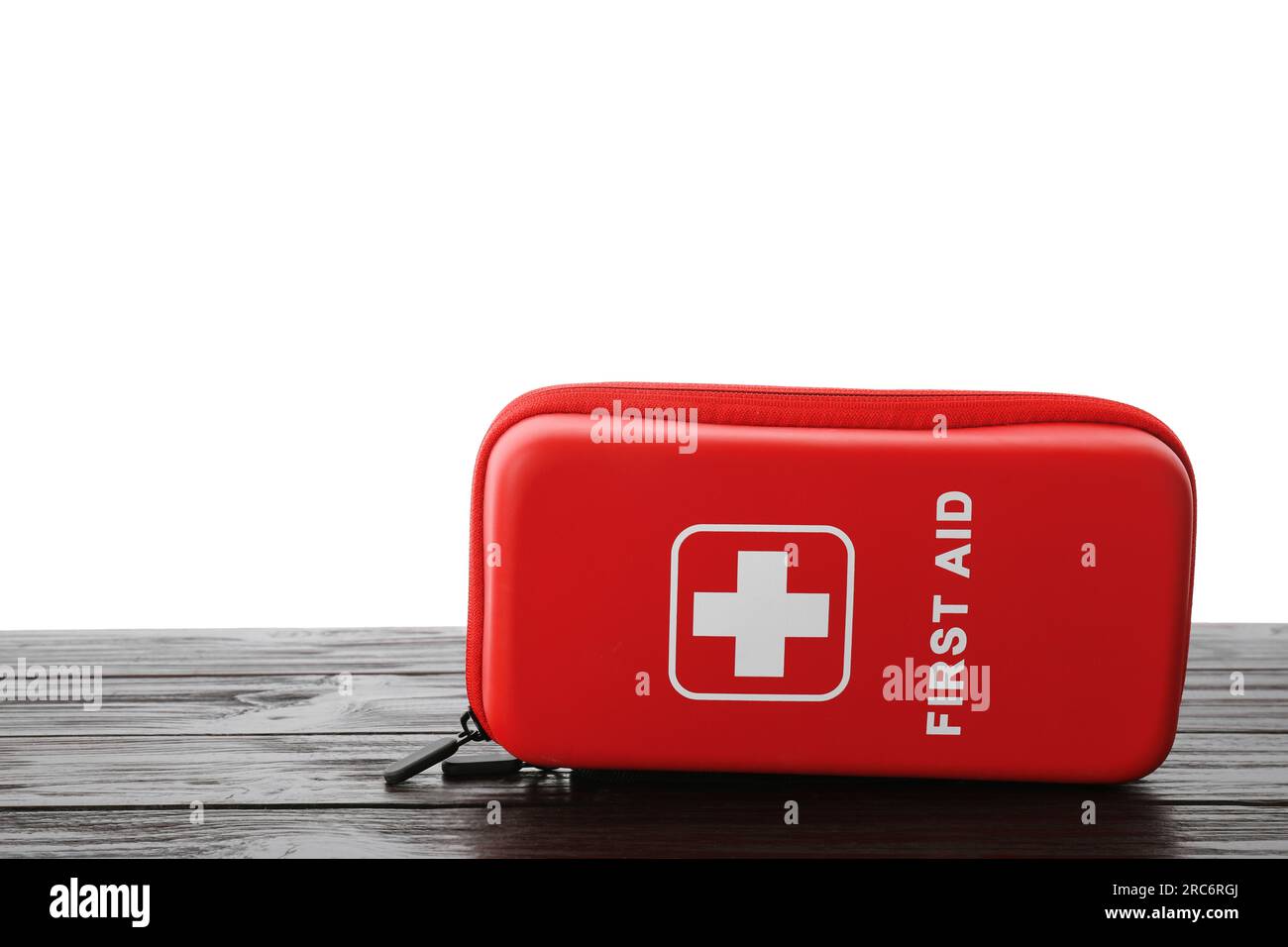 First aid kit on wooden table against white background Stock Photo - Alamy