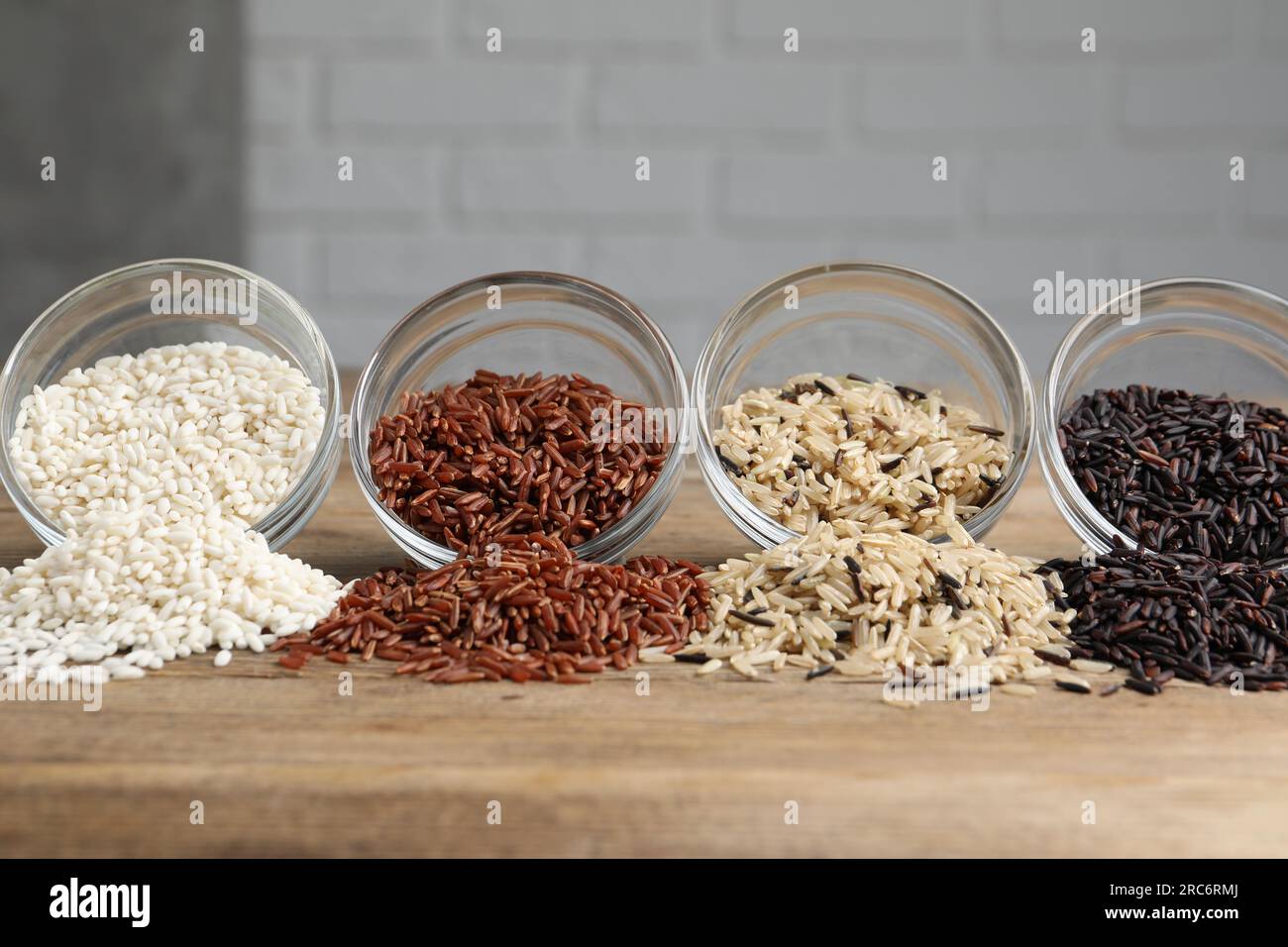 Different types of rice on wooden table, closeup Stock Photo - Alamy