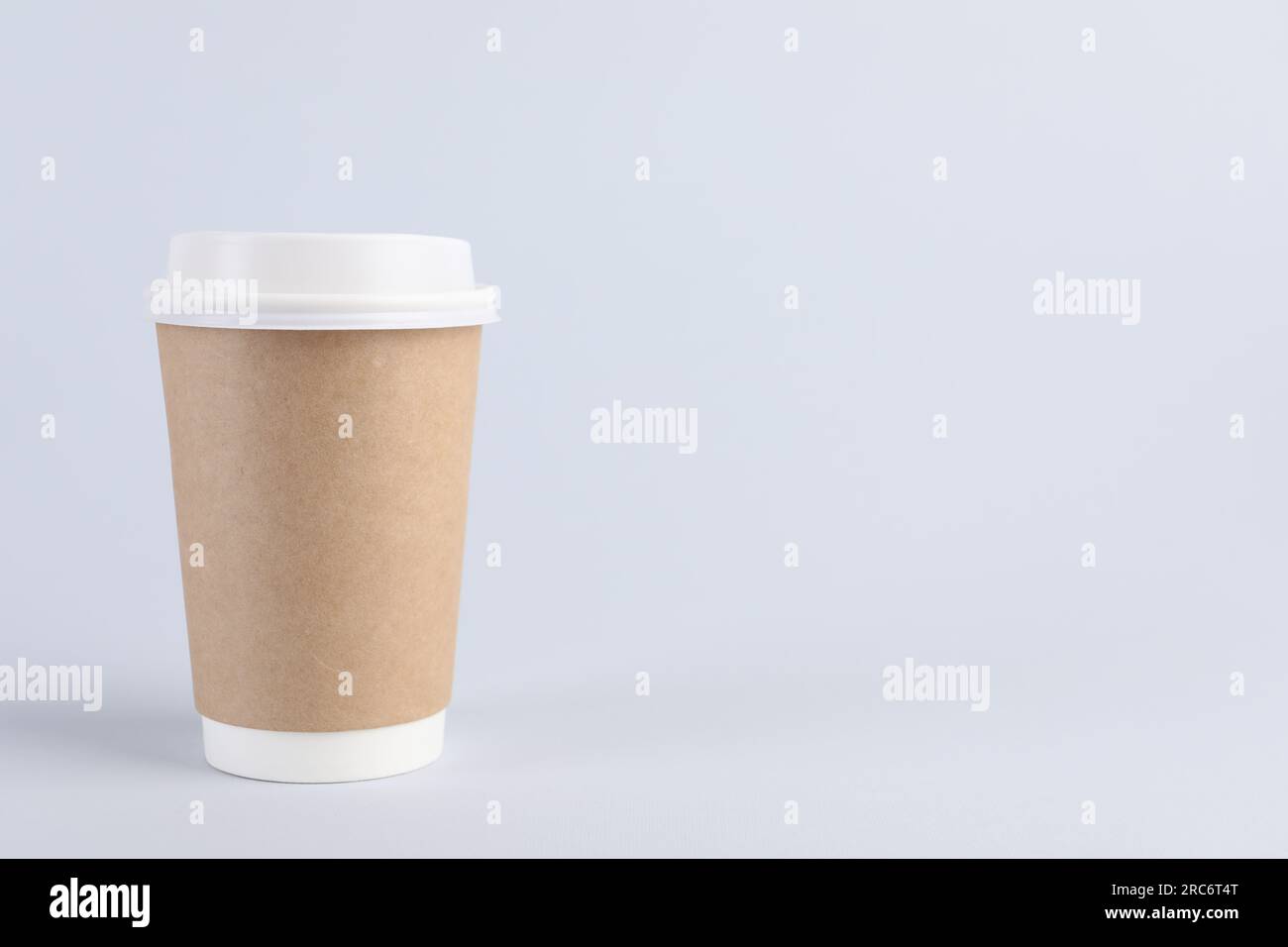 Paper cup with plastic lid on light background, space for text. Coffee ...