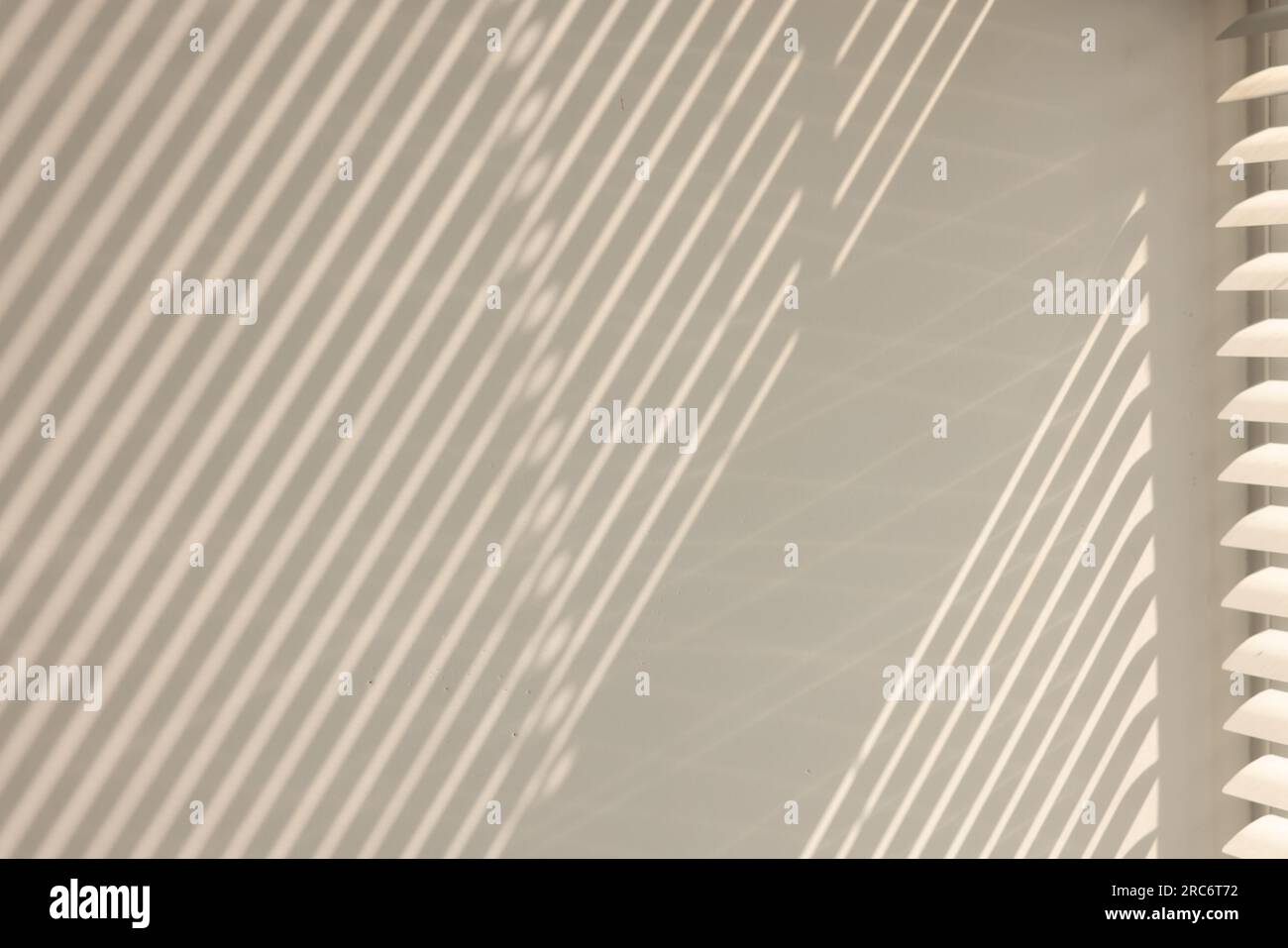 Shadow from window and blinds on beige wall indoors Stock Photo - Alamy