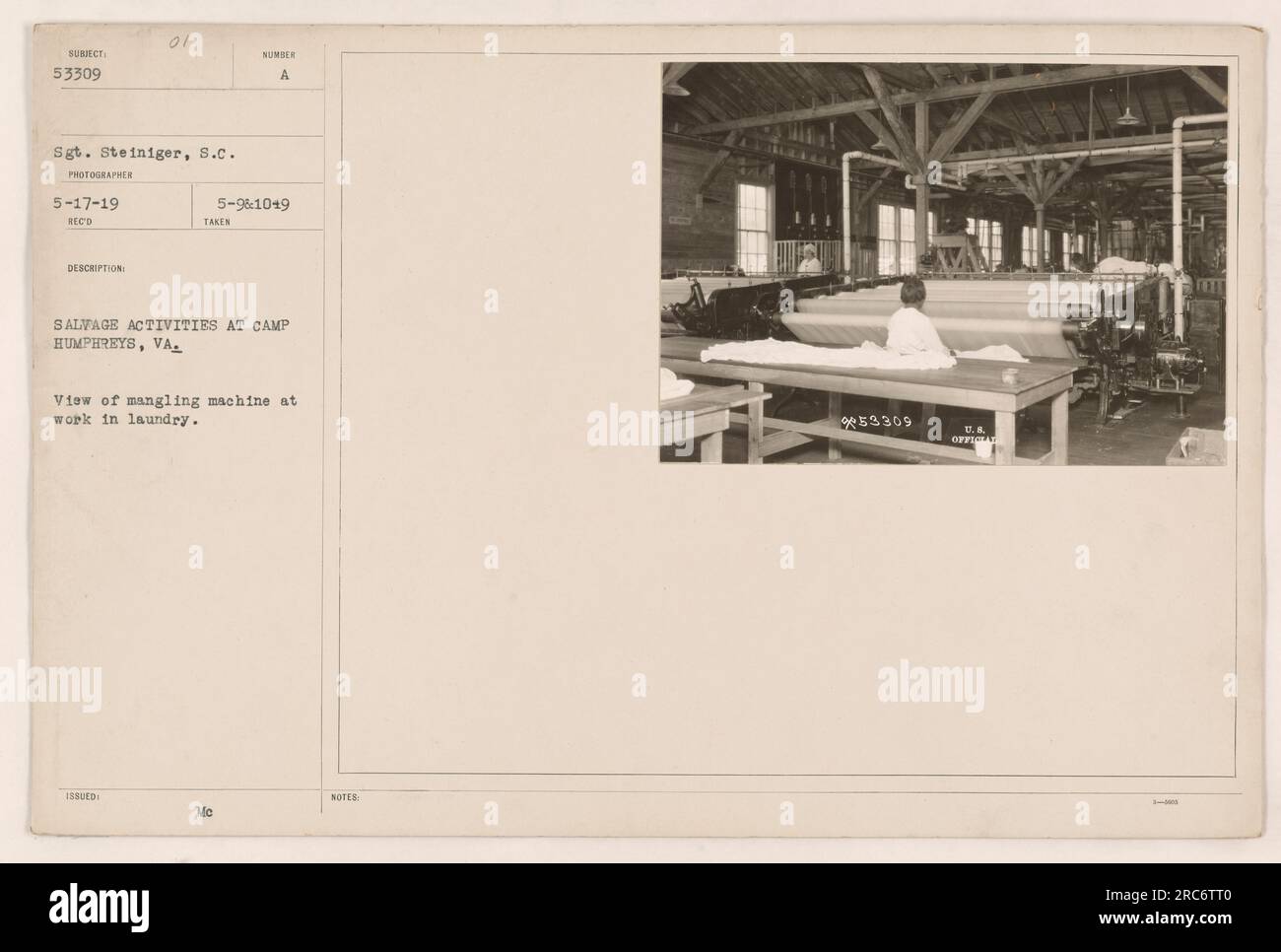 The image shows a mangling machine in operation at the laundry facility ...