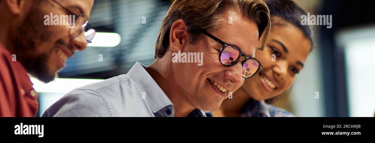 Positive male boss discussing project results and sharing ideas with ...