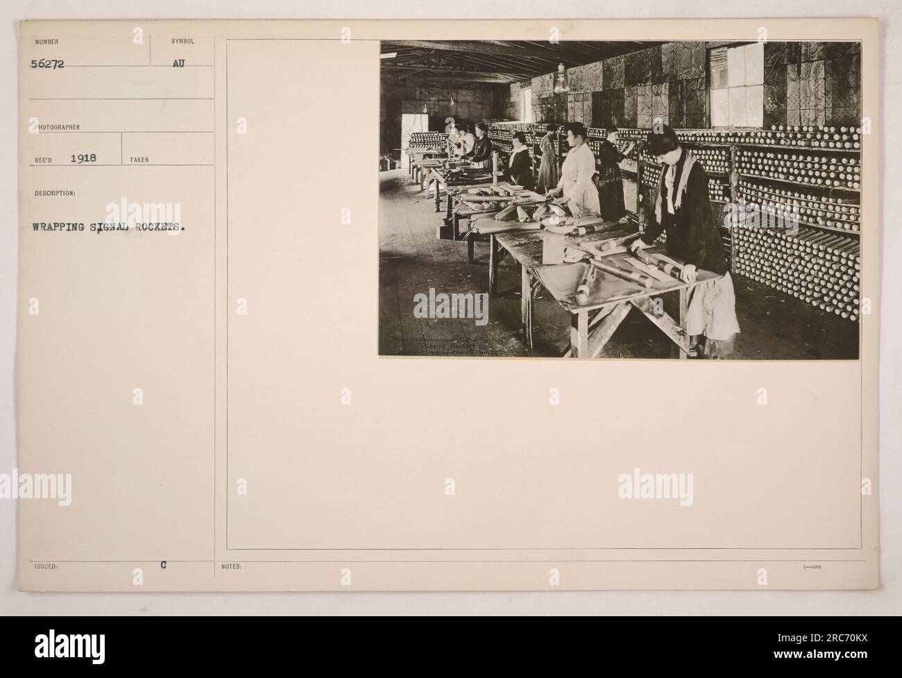 A soldier is seen wrapping signal rockets, marked with the symbol "AU ...