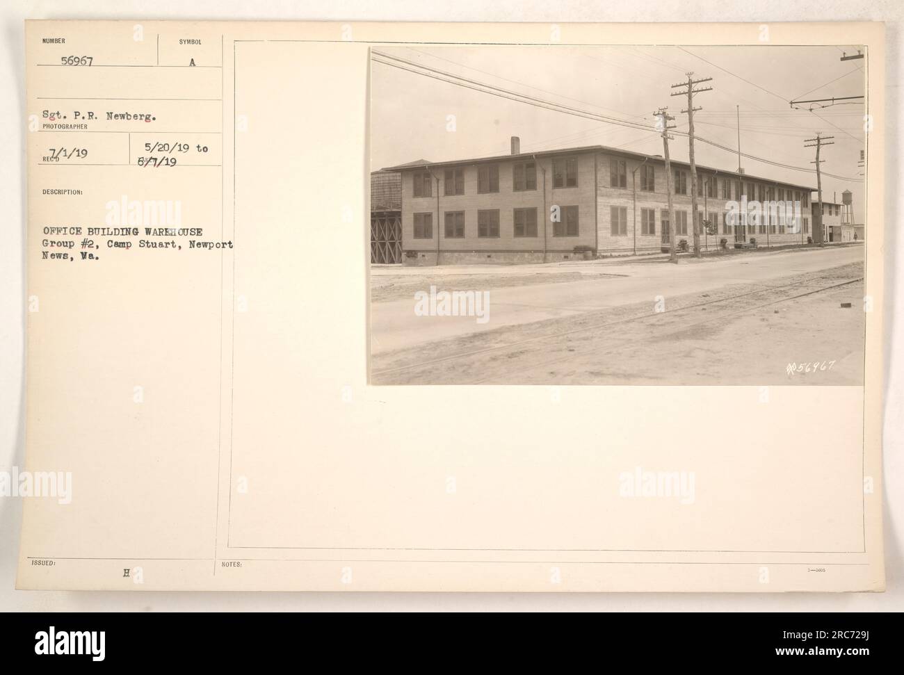 Group of Army personnel standing outside an office building warehouse ...