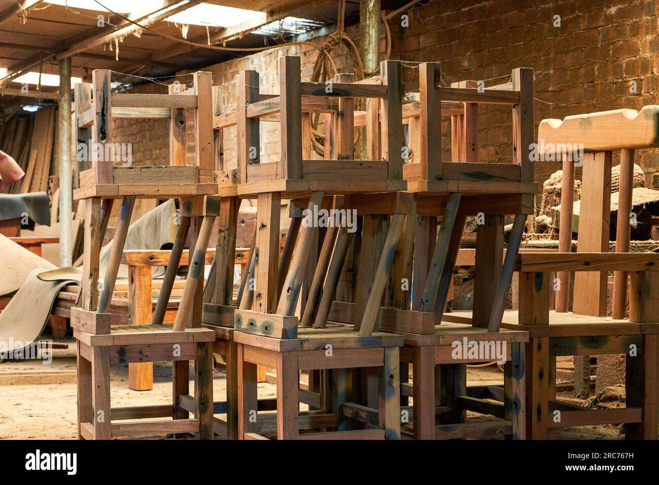 A busy and messy furniture processing factory Stock Photo - Alamy