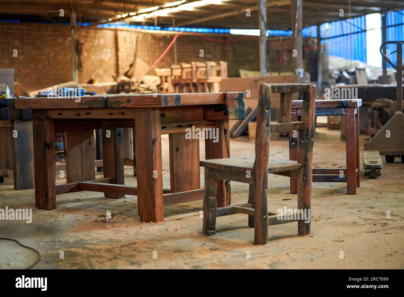 A busy and messy furniture processing factory Stock Photo - Alamy
