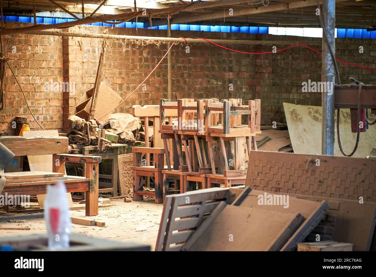 A busy and messy furniture processing factory Stock Photo - Alamy