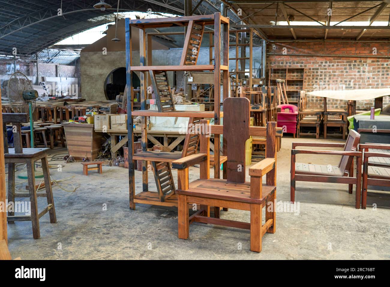 A busy and messy furniture processing factory Stock Photo - Alamy
